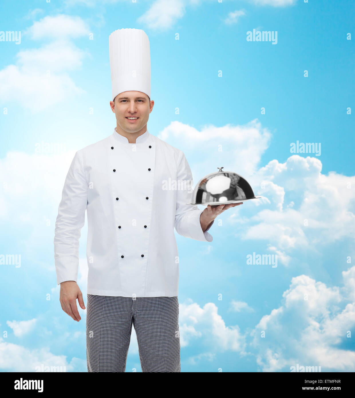 happy male chef cook holding cloche Stock Photo - Alamy