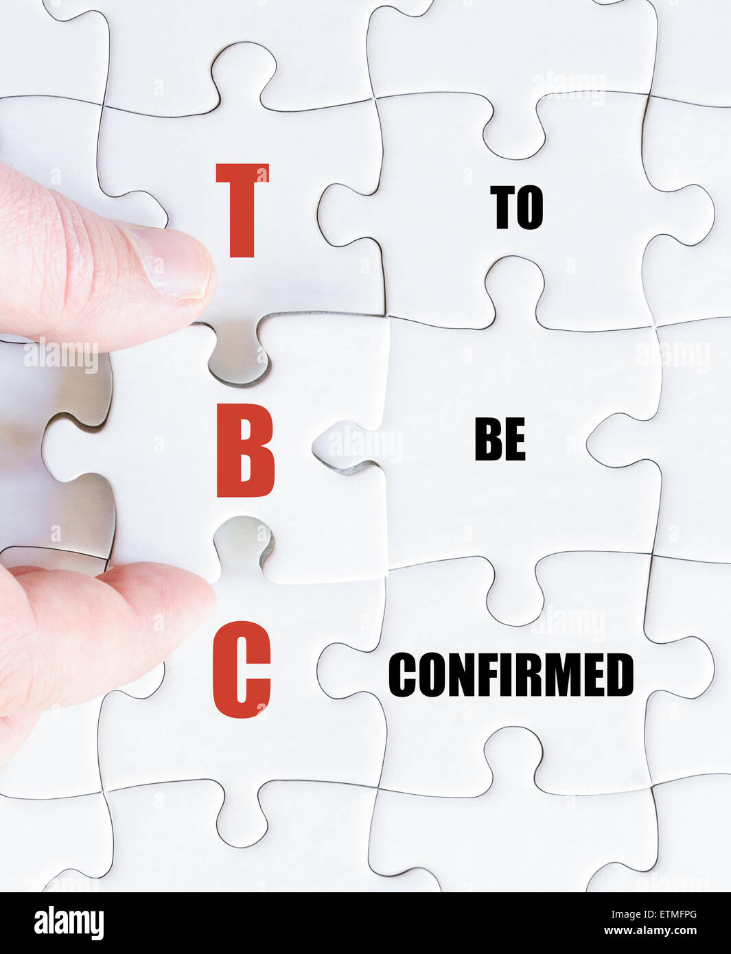 Hand of a business man completing the puzzle with the last missing ...