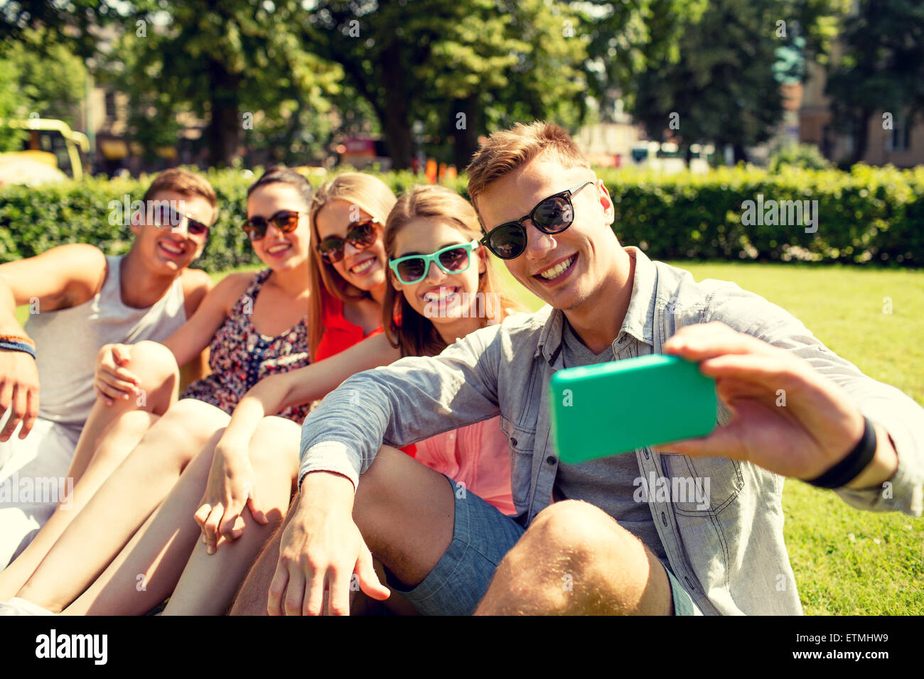 smiling friends with smartphone making selfie Stock Photo - Alamy