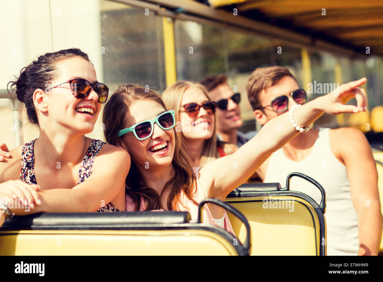 group of smiling friends traveling by tour bus Stock Photo - Alamy