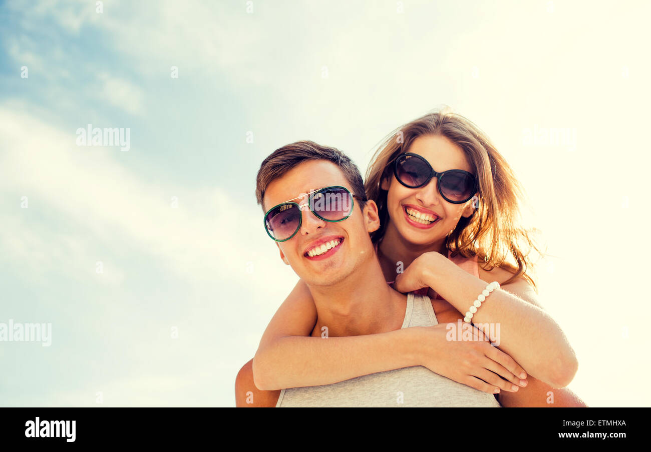 smiling couple having fun over sky background Stock Photo - Alamy