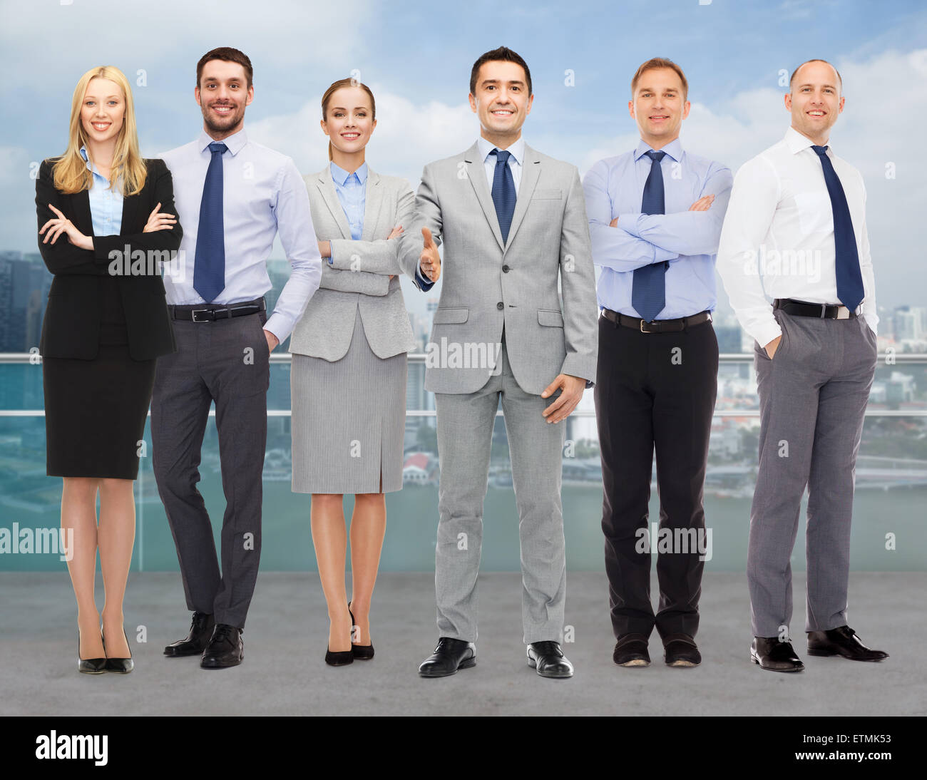 group of smiling businessmen making handshake Stock Photo - Alamy