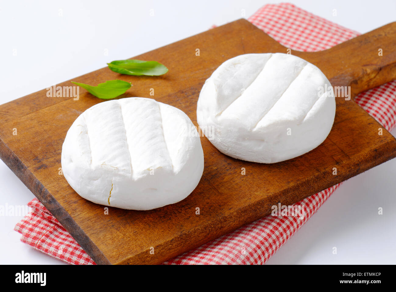 two wheels of soft creamy cheese with white mold Stock Photo - Alamy