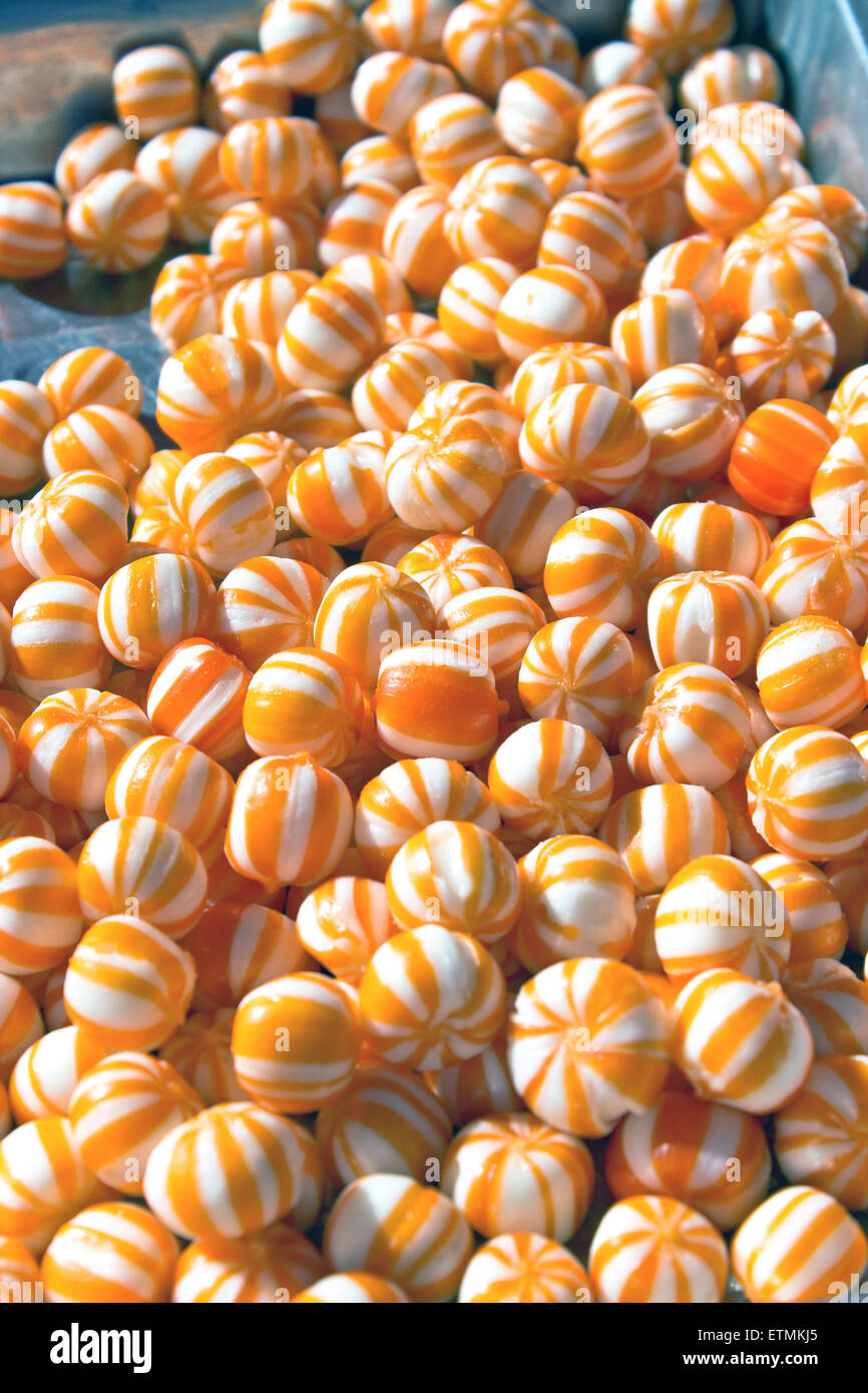 Round yellow candies as background Stock Photo - Alamy