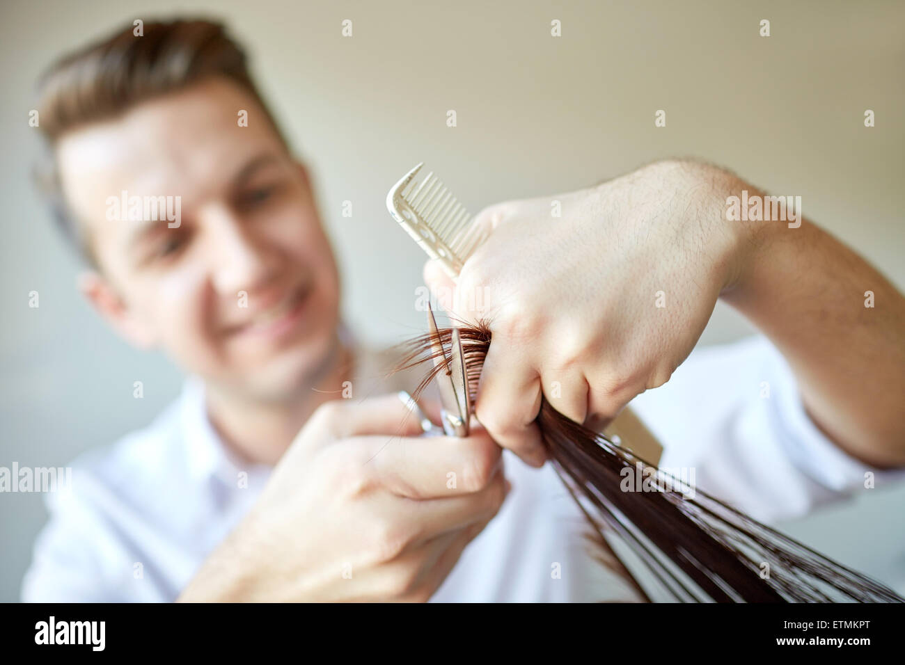 stylist with scissors cutting hair tips at salon Stock Photo - Alamy