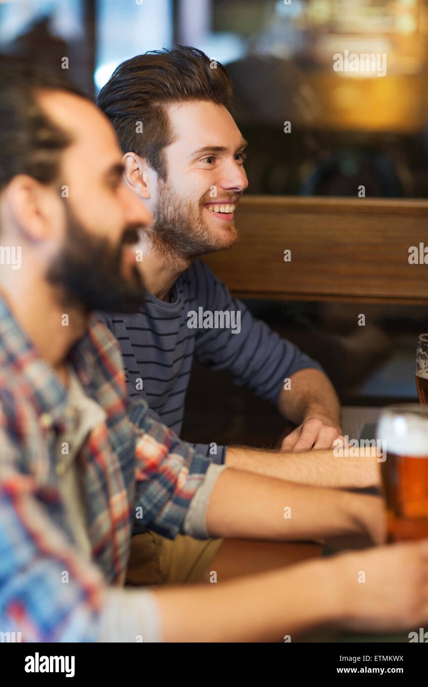 happy male friends drinking beer at bar or pub Stock Photo - Alamy