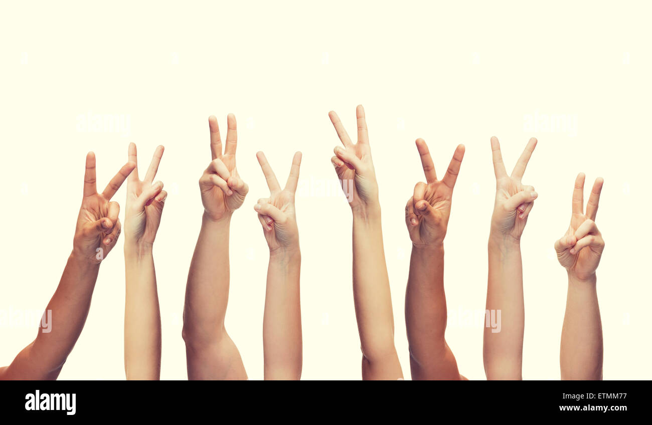 human hands showing v-sign Stock Photo - Alamy
