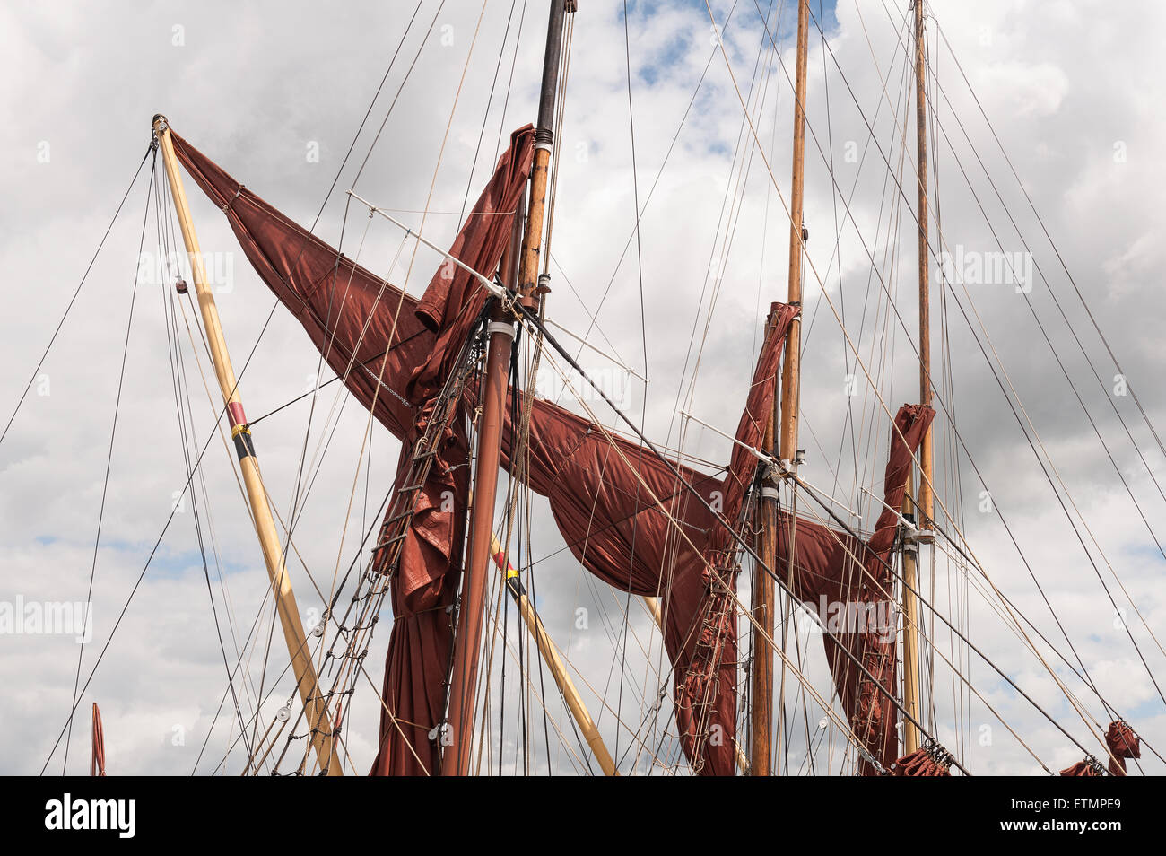 Wrapped up red ochre sails typical of the old Thames sailing barges ready to be used when ...