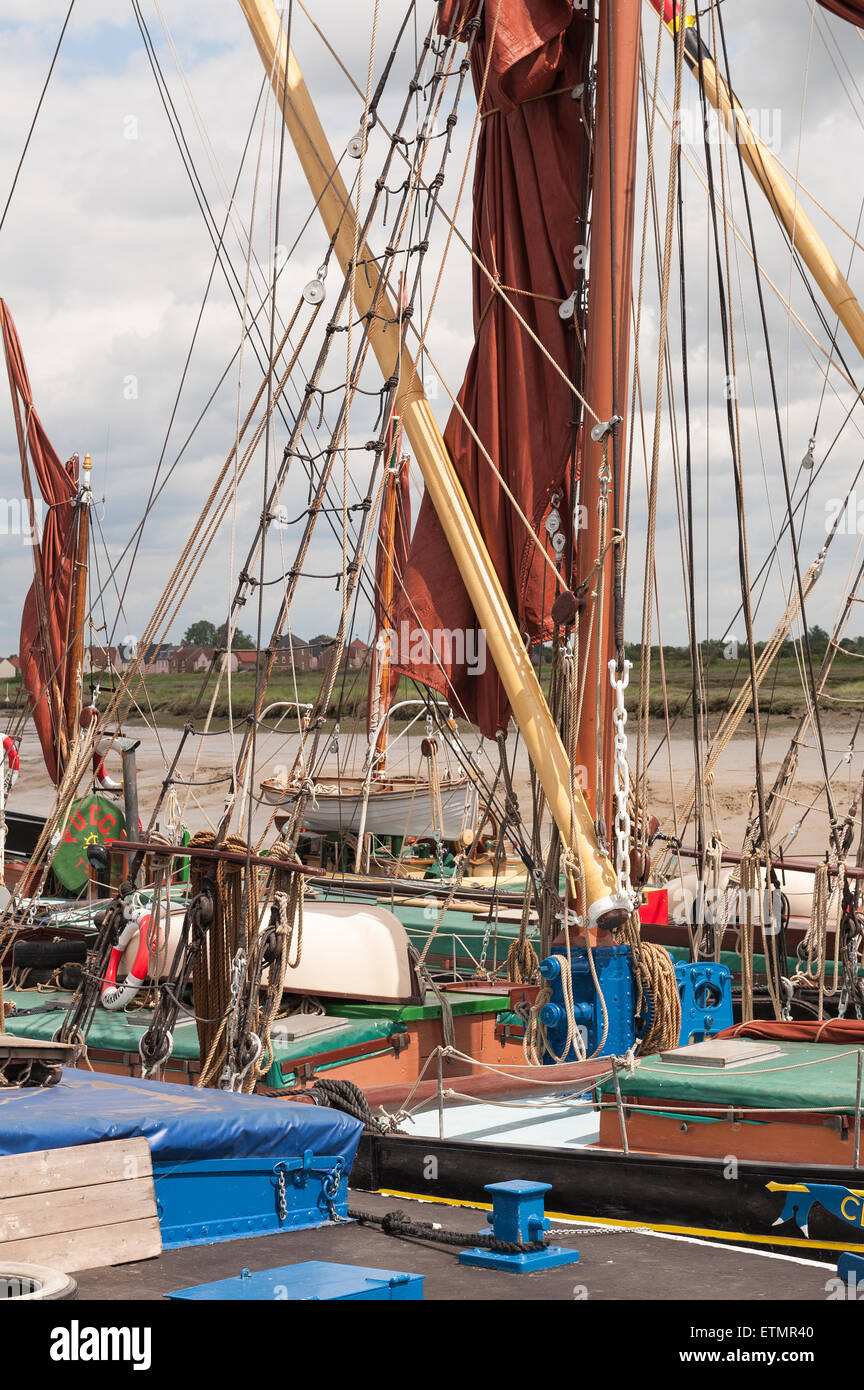 Moored old sailing barges at the Hythe Quay at lowtide supported by ...