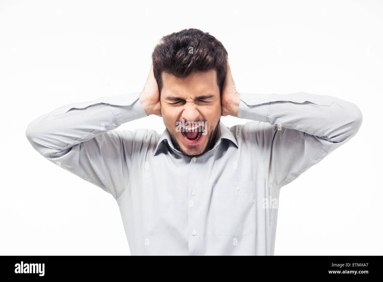 Casual man covering his ears and shouting isolated on a white ...