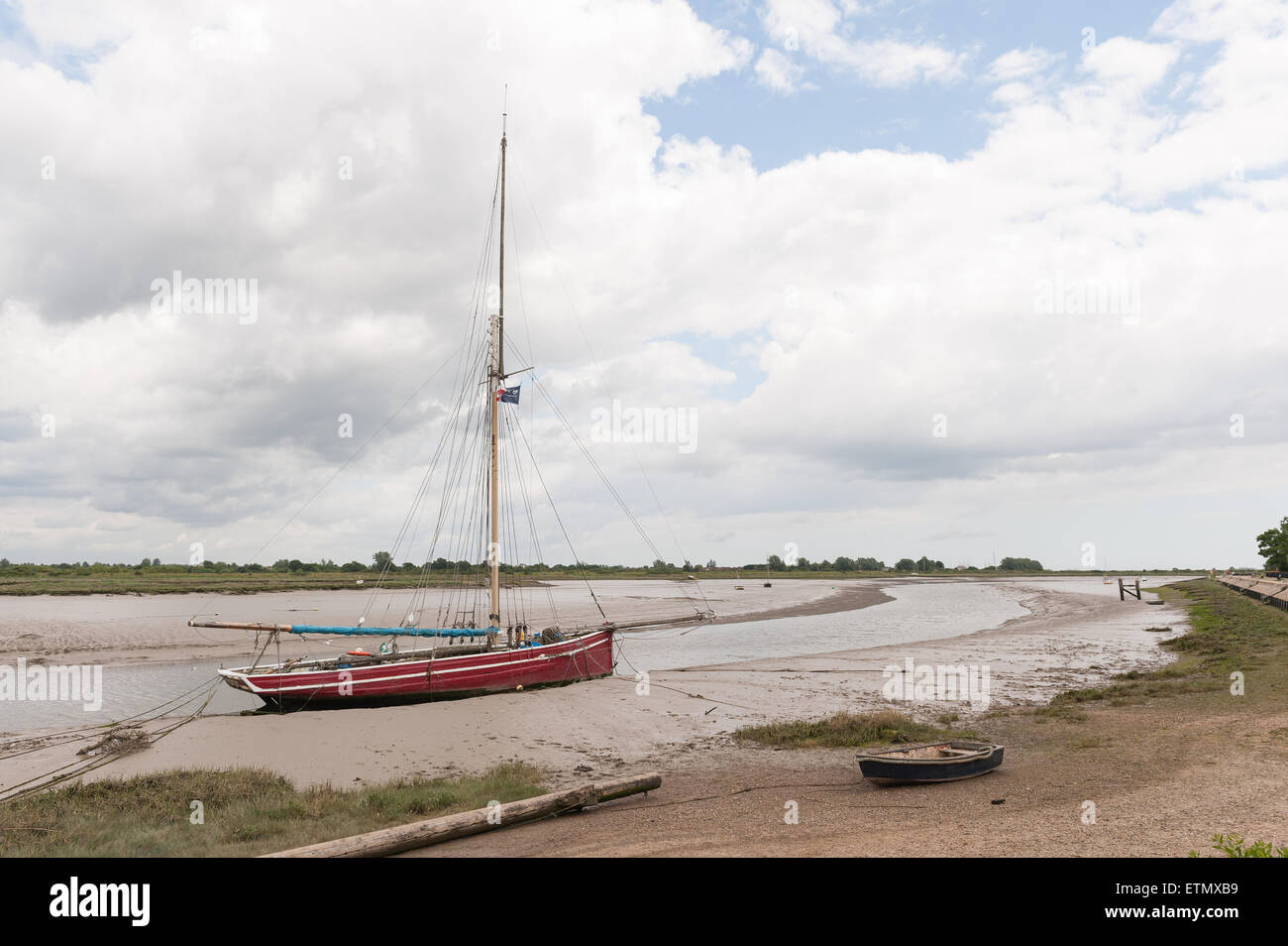 marooned sailing boat boats raised up on silty mud and sand at low tide ...