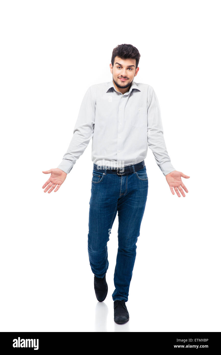 Full length portrait of a casual young man walking and shrugging ...