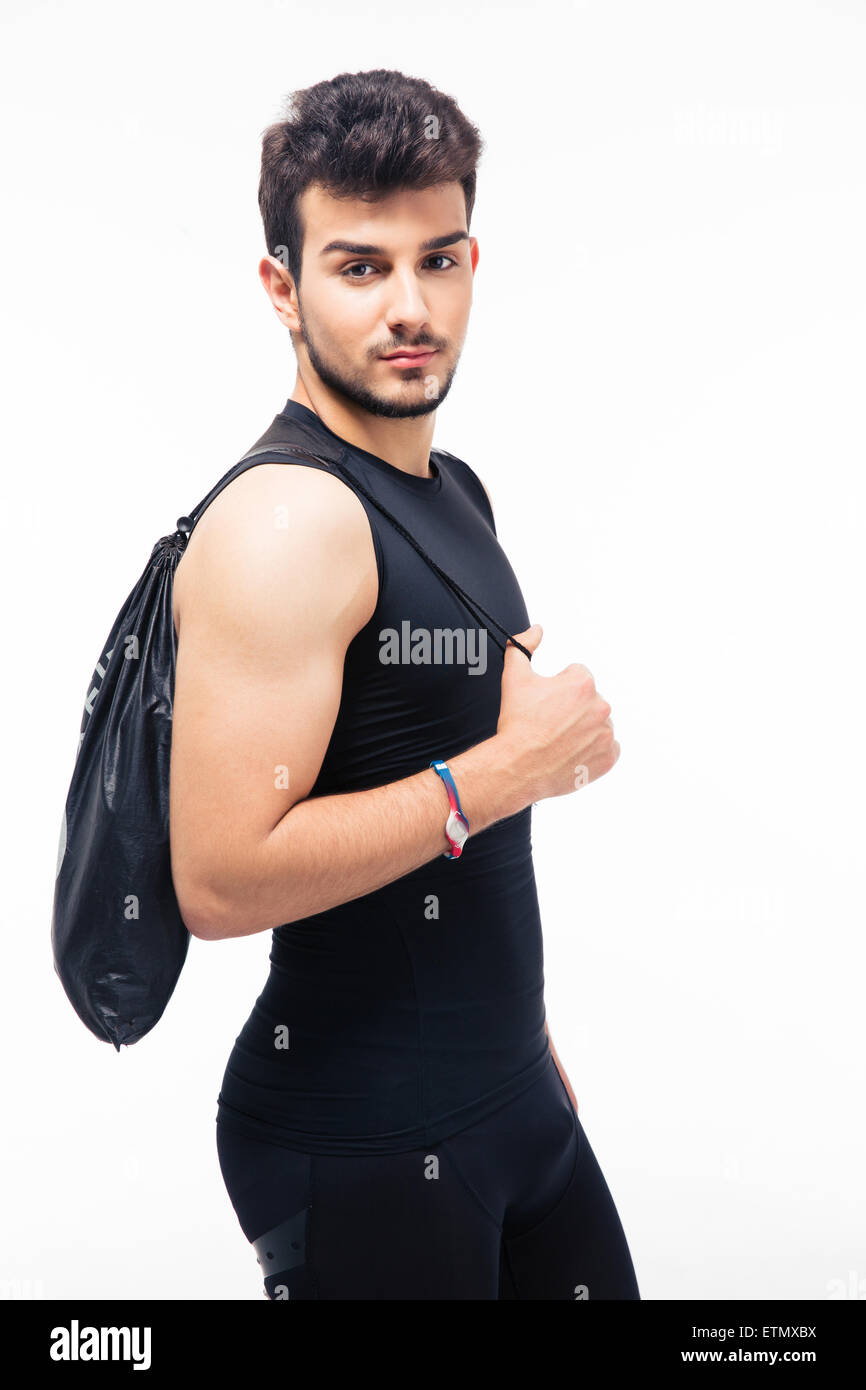 Portrait of a sports man with backpack standing isolated on a white ...