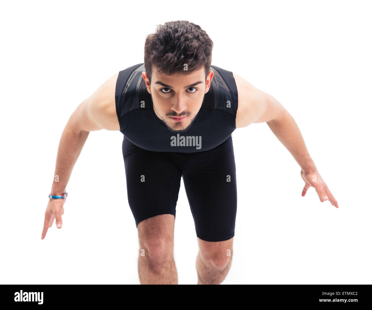 Sports man getting ready to run isolated on a white background. Looking ...