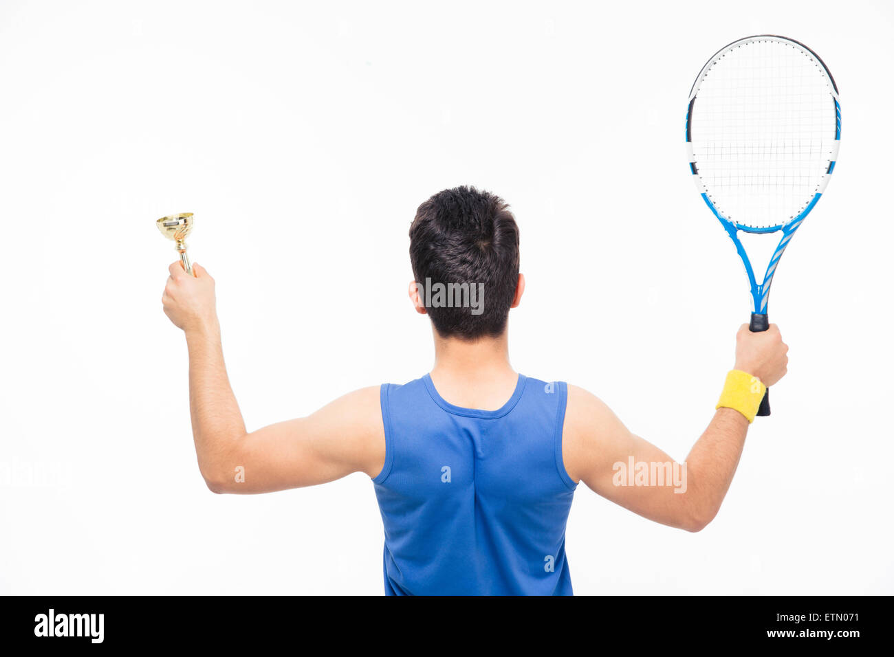 Back view portrait of a man holding tennis racket and cup isolated on a ...