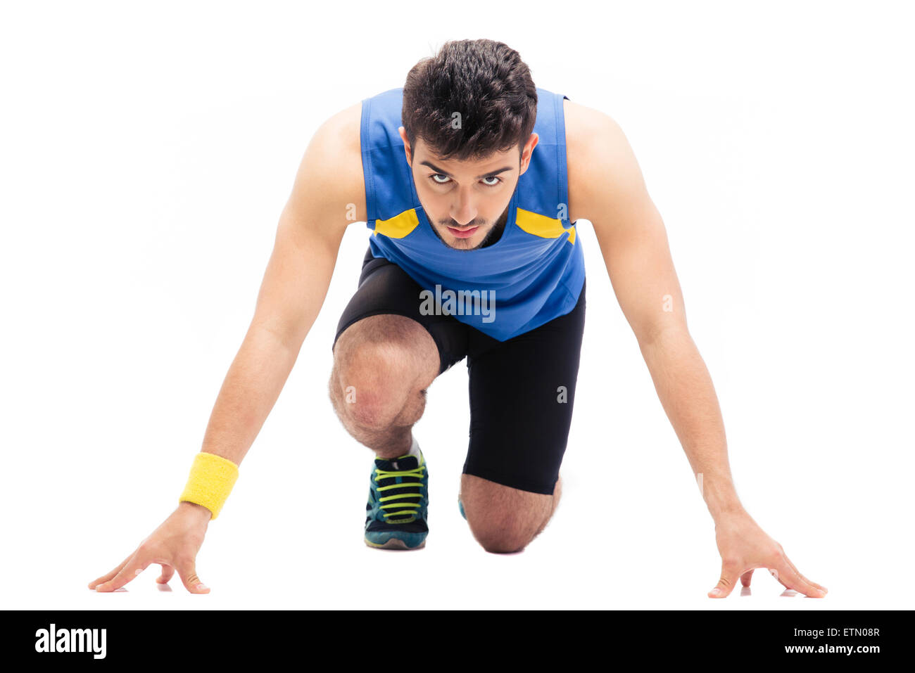 Sports man getting ready to run isolated on a white background. Looking ...