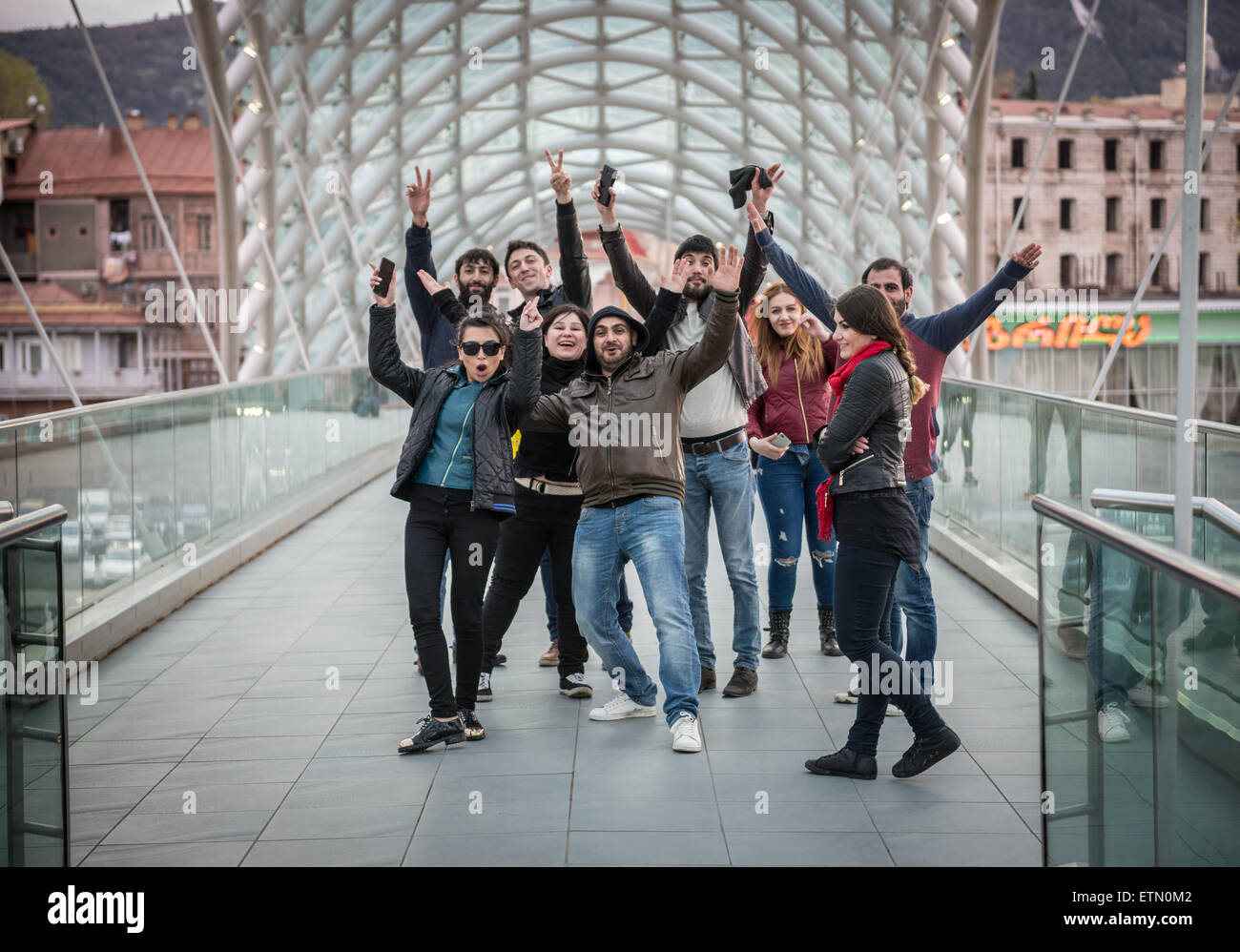 Group of young people at pedestrian Bridge of Peace (georgian ...