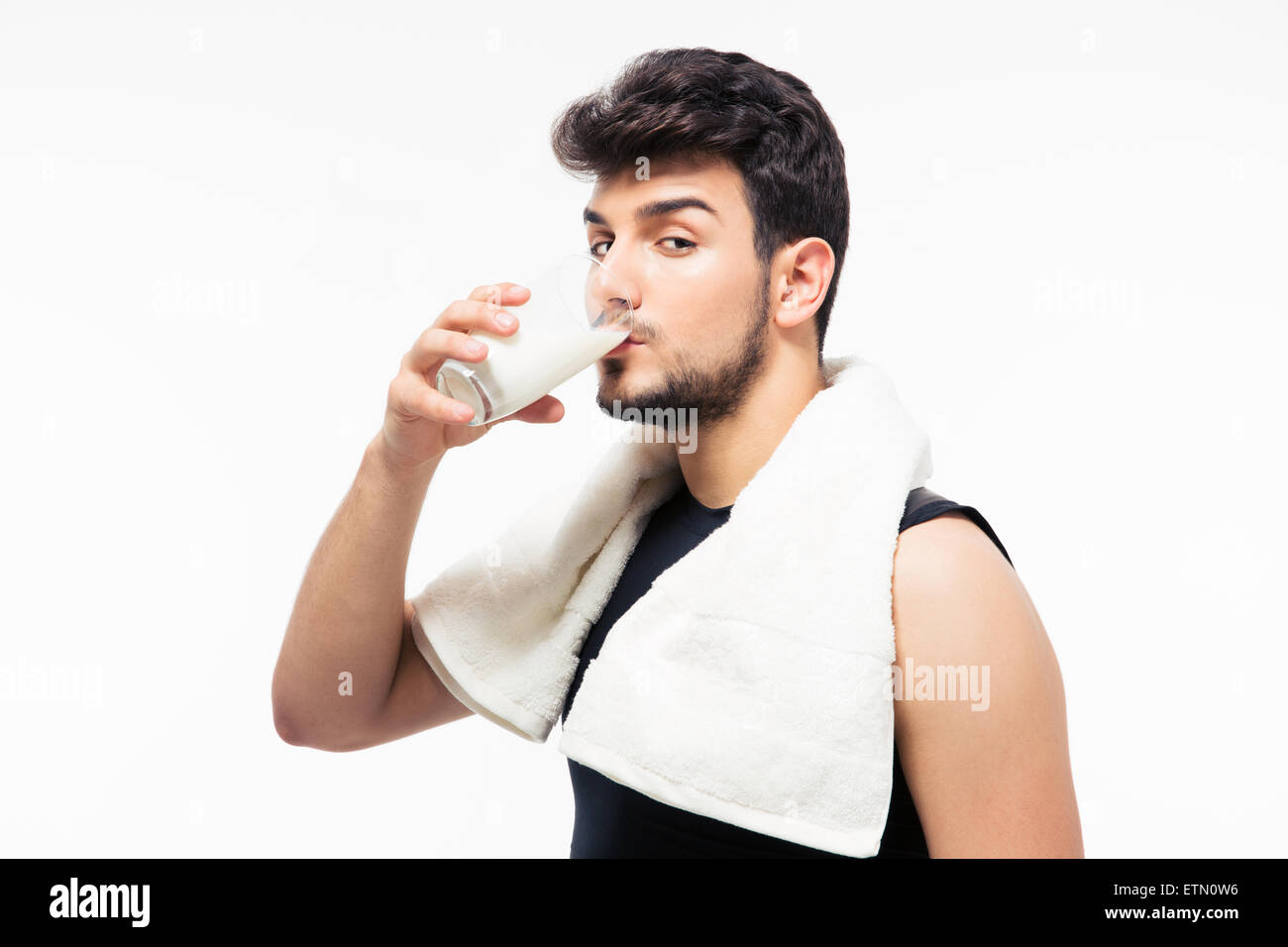Handsome man drinking milk isolated on a white background. Looking at ...