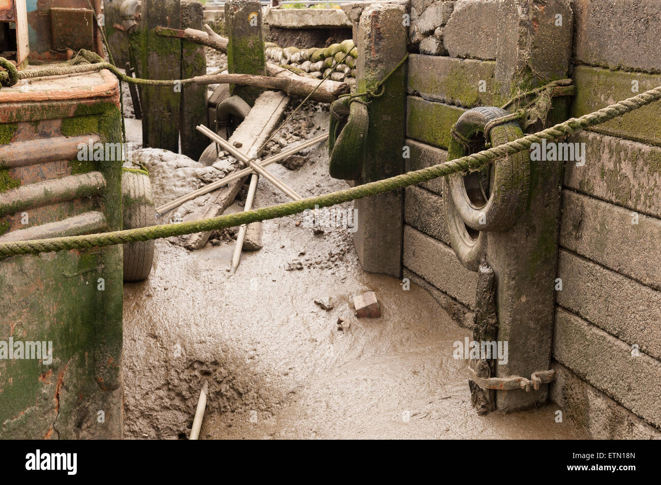 silted mud and muddy silty walls of the Hythe at low tide with caked ...