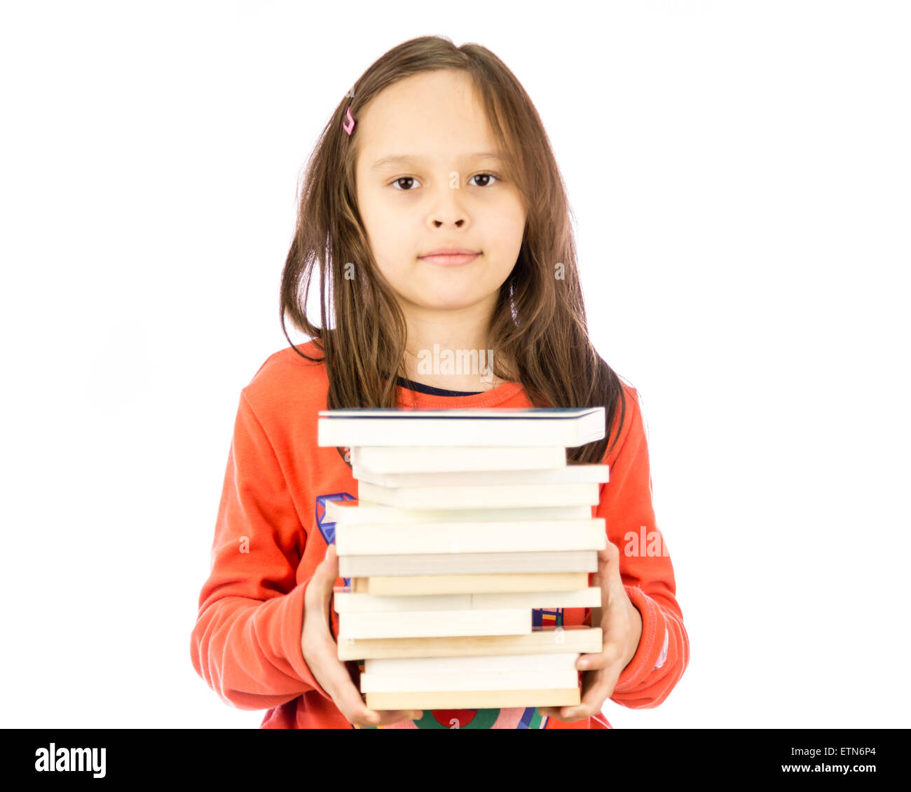 Young girl carrying a pile of books Stock Photo - Alamy