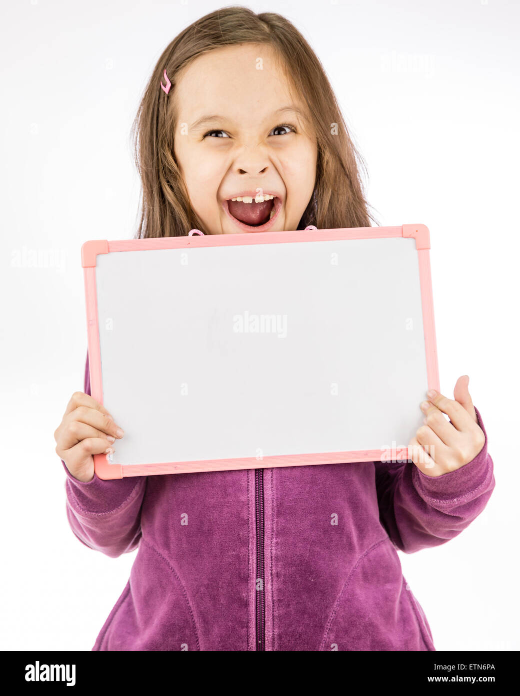 Young girl holding blank whiteboard sign, pulling face Stock Photo - Alamy