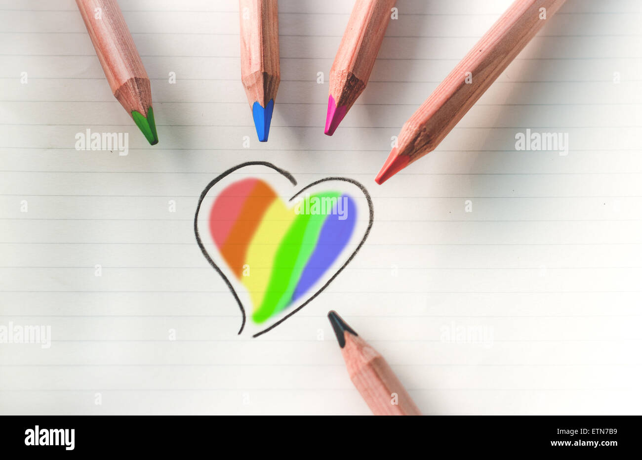 Colored pencils and a drawing of a multi coloured heart Stock Photo - Alamy