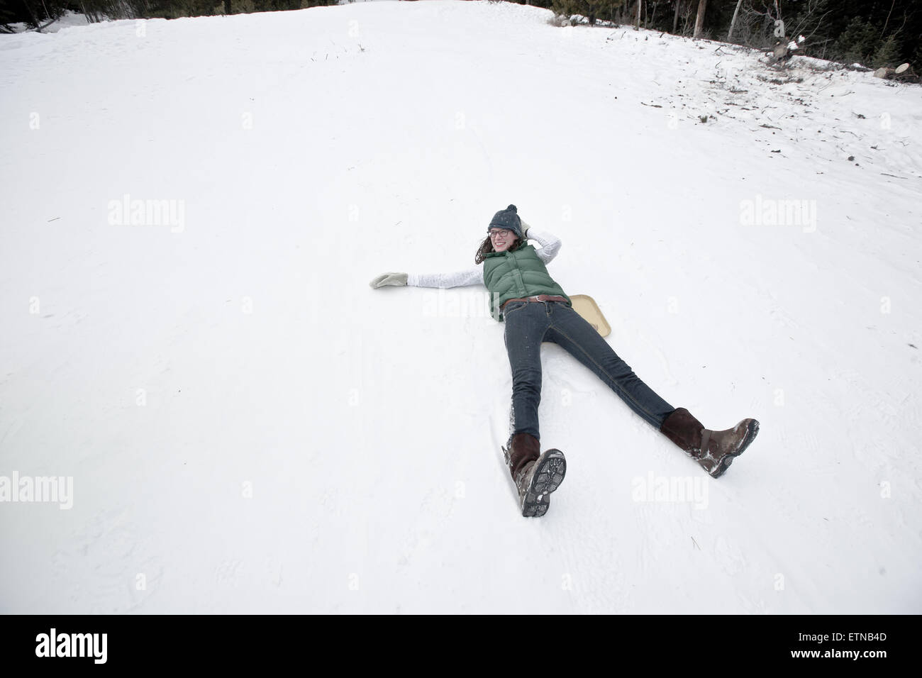Playful woman lying in snow hi-res stock photography and images - Alamy