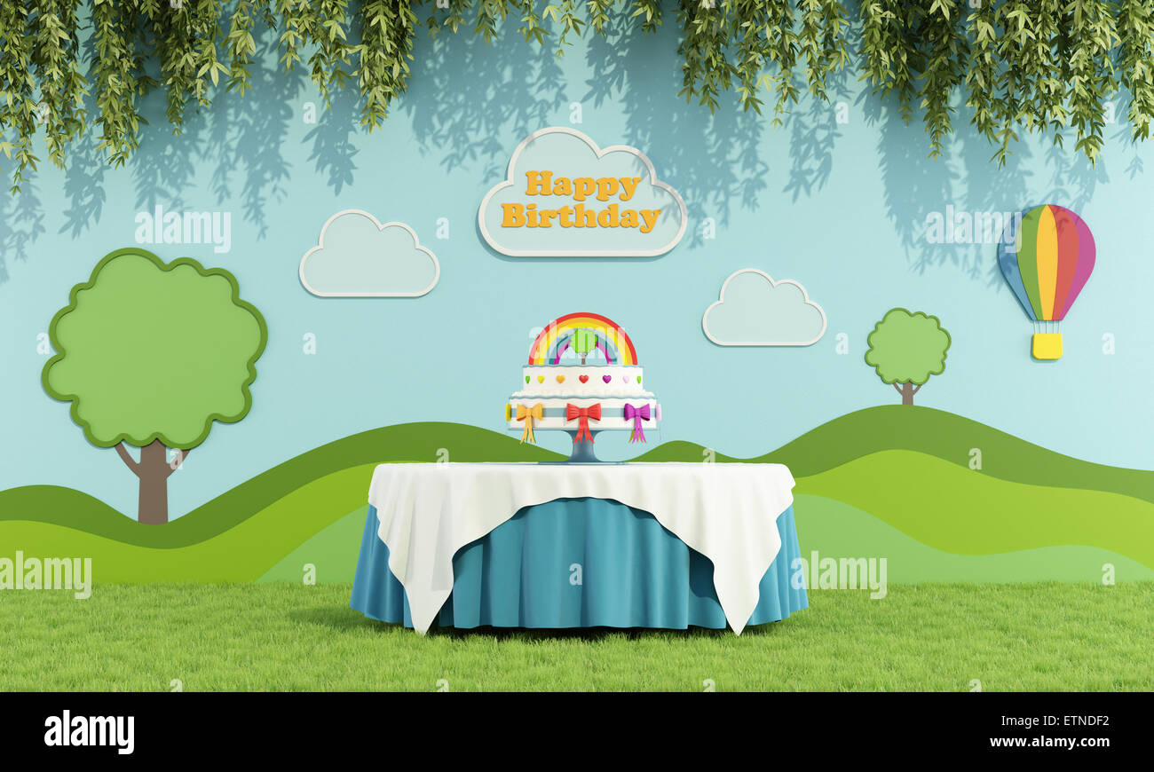 Birthday party in a garden with round table with cake and colorful ...