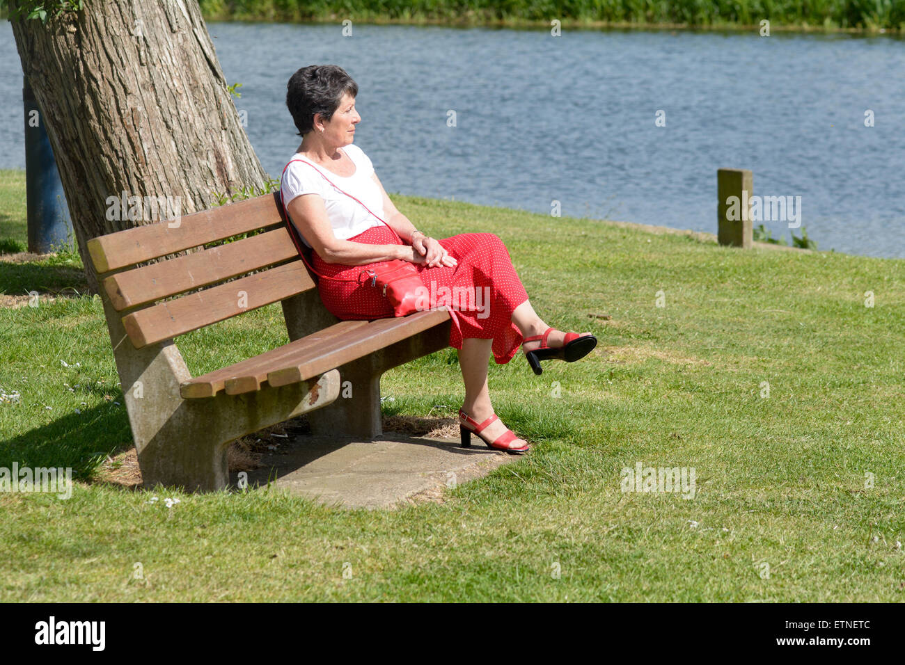 Lady sitting on a bench hi-res stock photography and images - Alamy