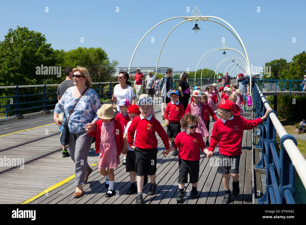 School children walking along Southport Pier with their teacher Stock ...