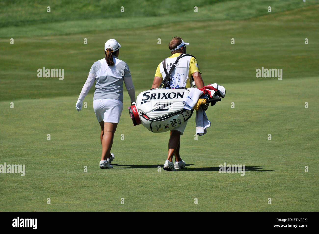 Inbee park and caddie Brad Beecher walk up the ninth fairway during the ...