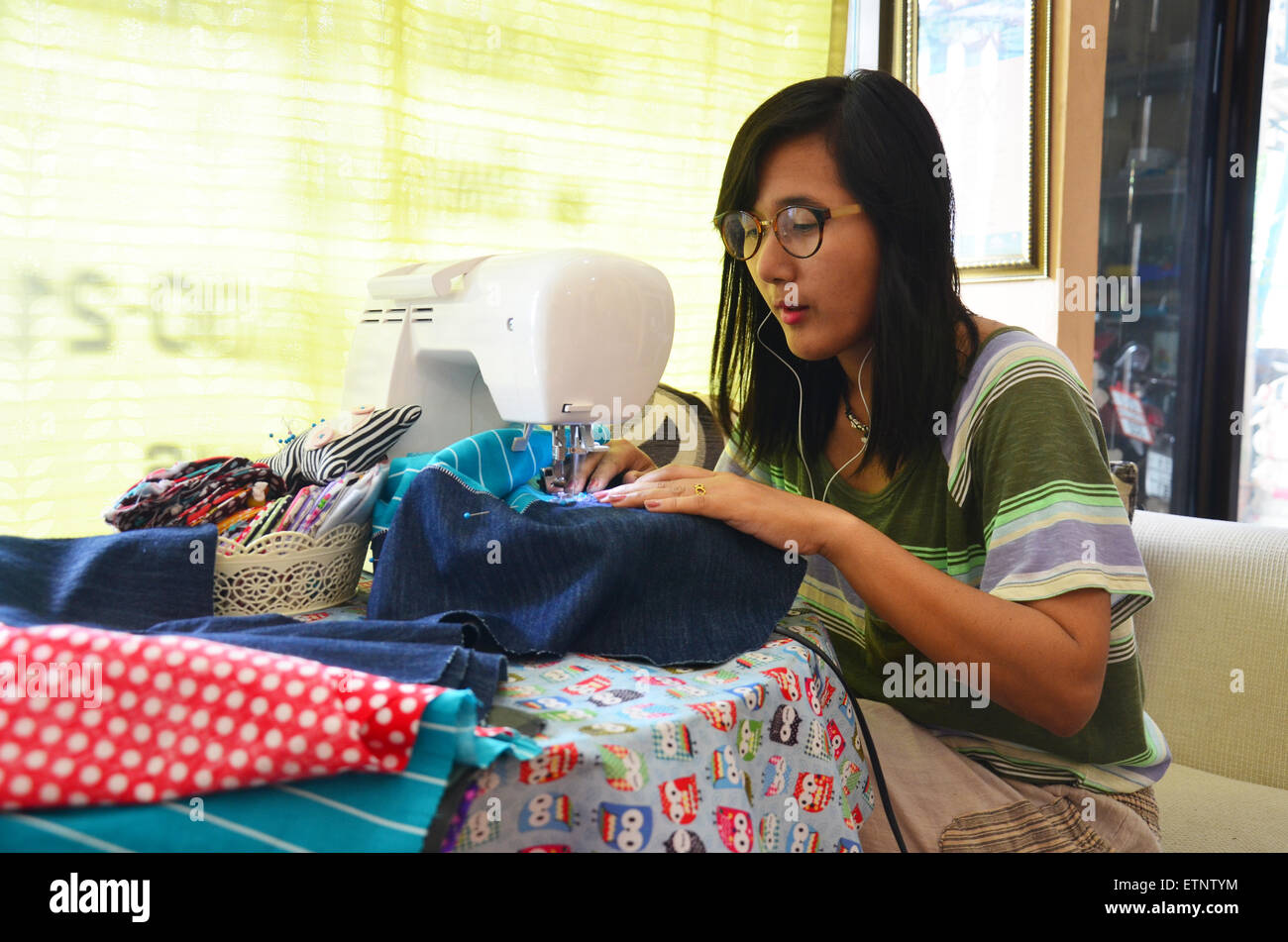 Asian women use machine sewing clothes Stock Photo - Alamy
