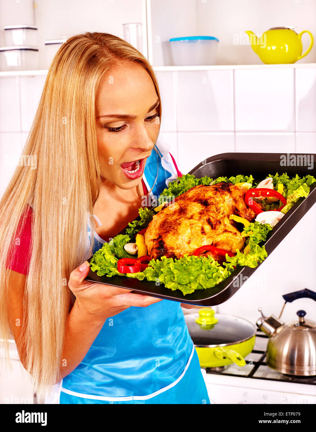 Woman cooking chicken at kitchen Stock Photo - Alamy