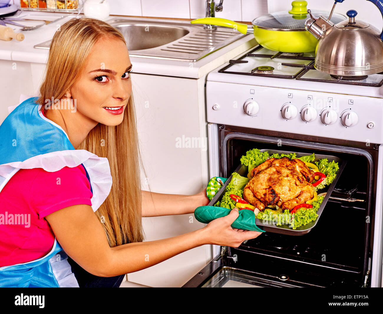 Woman cooking chicken at kitchen Stock Photo - Alamy