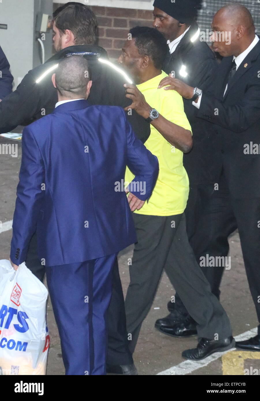 Football legend Pele is surrounded by fans and security at the Subway ...
