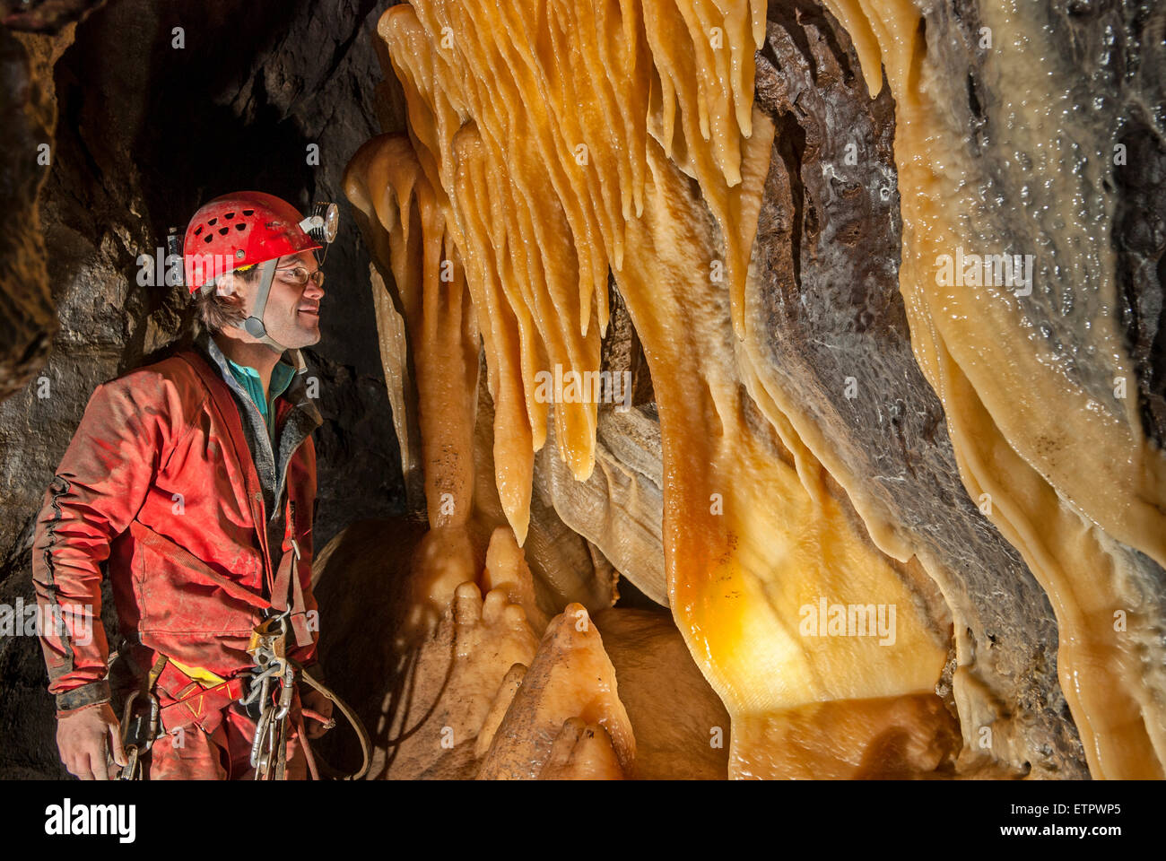 Cave explorer in front of sinter flags Stock Photo - Alamy