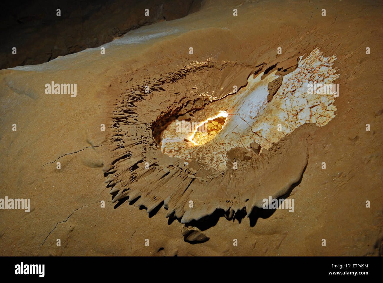 Water dripping point at Clay ground in a cave Stock Photo - Alamy