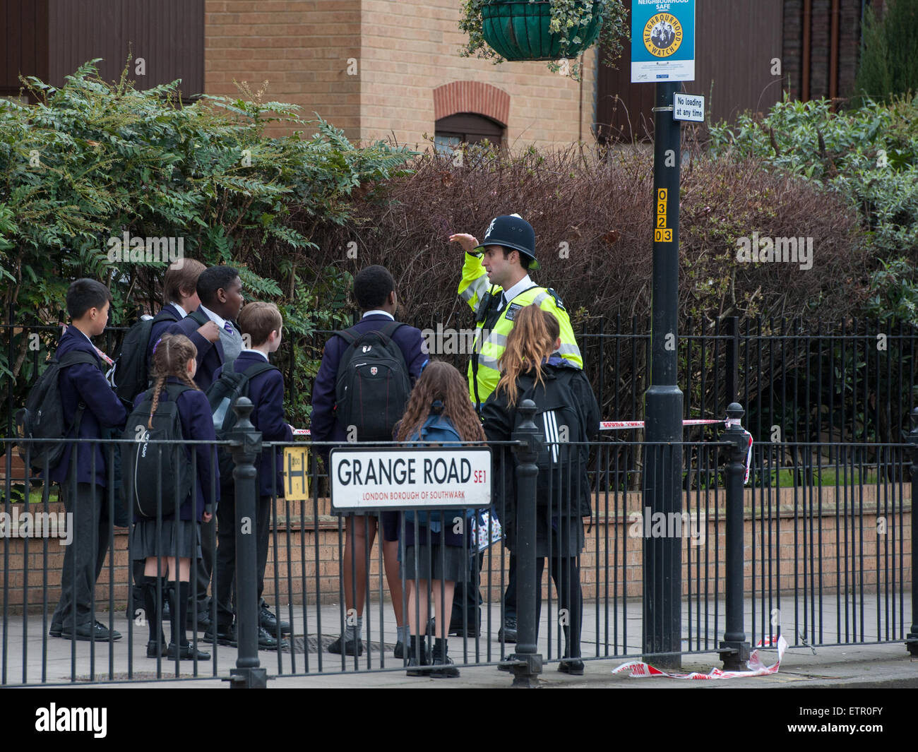 Police man the inner cordon on the Grange in London's Bermondsey ...