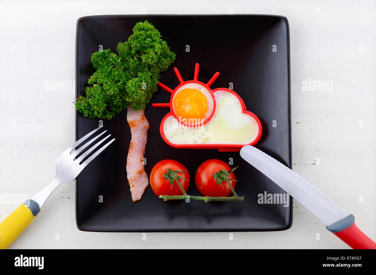 Bright happy breakfast with sunny egg, bacon tree with parsley leaves ...