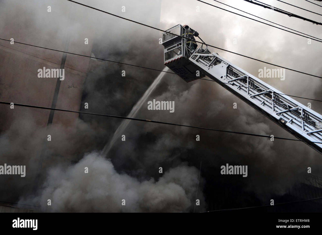 Fire fighters extinguishing from burning four-story departmental store ...