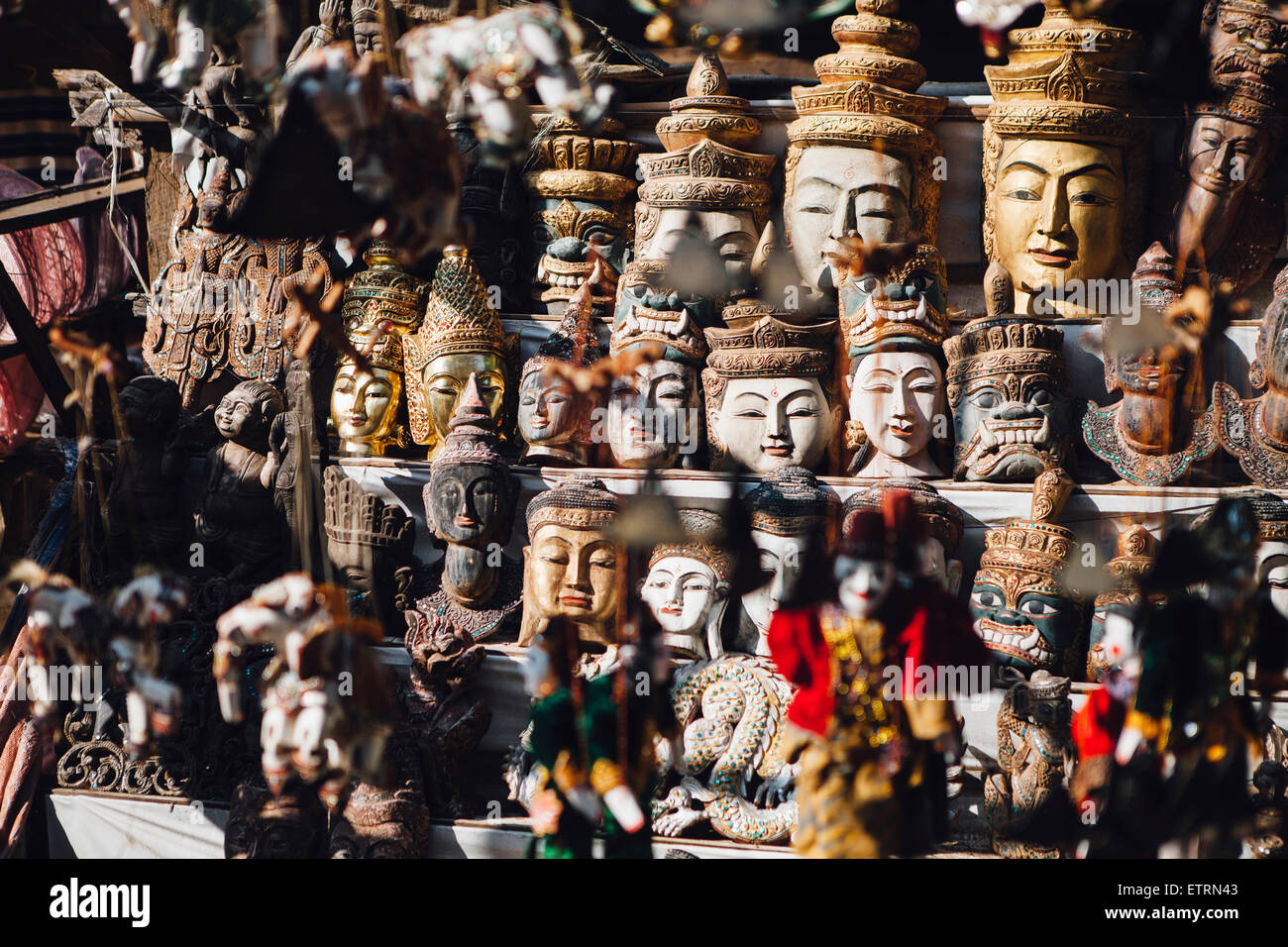 Various Burmese statues/masks on display at market in Bagan, Myanmar ...