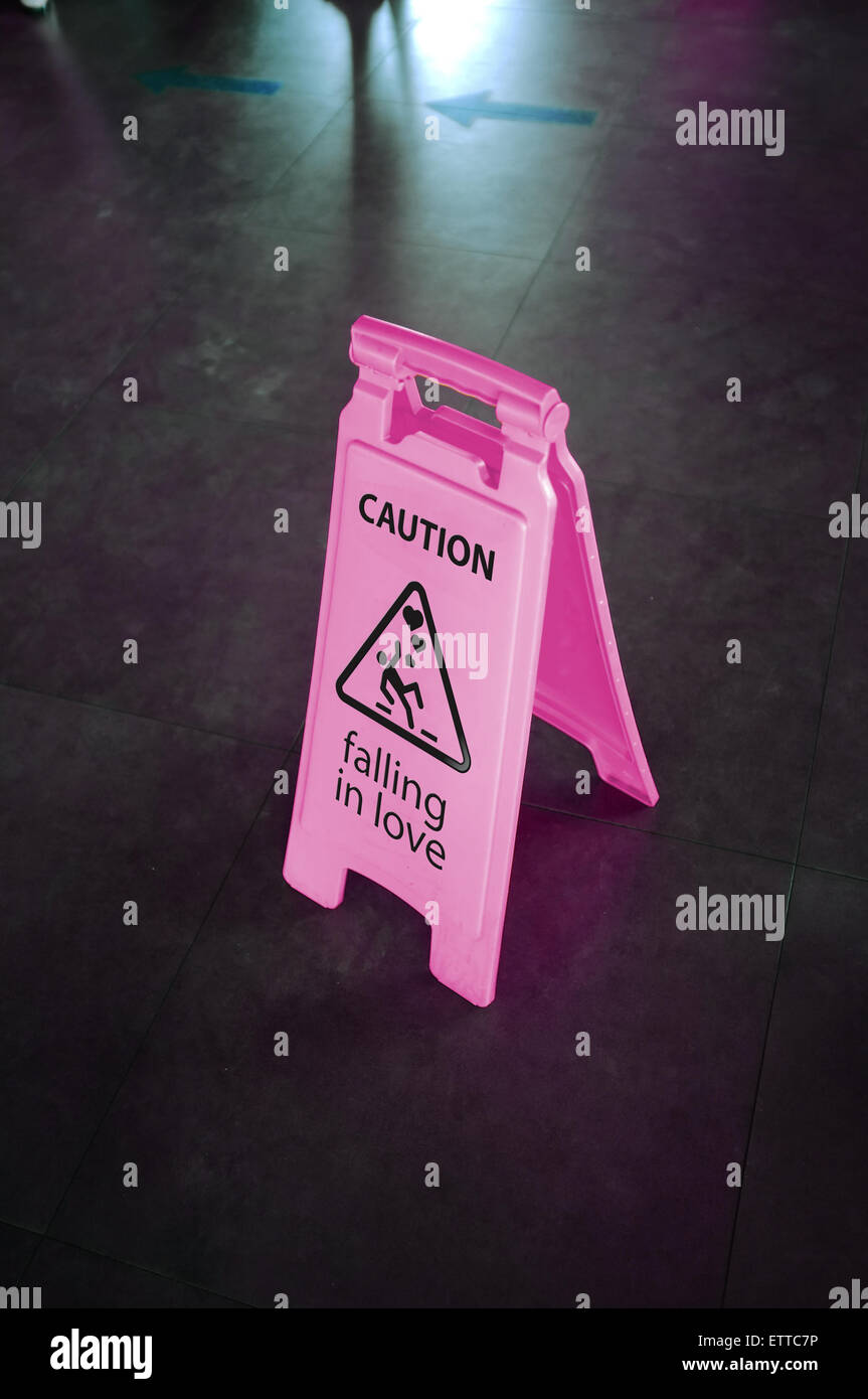 Caution sign for warning, falling in love, on a floor Stock Photo - Alamy