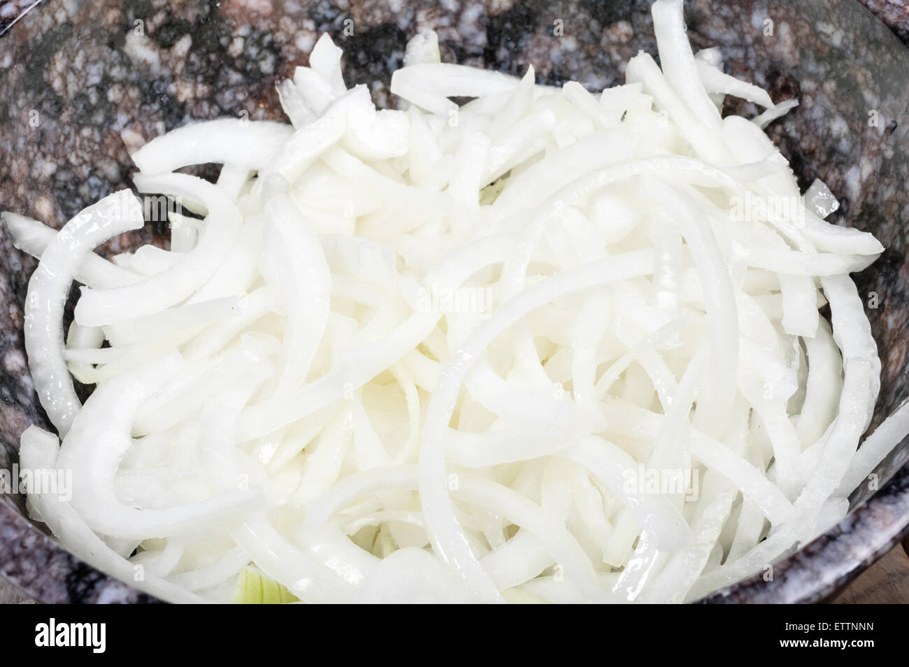 Onions sliced and prepared for cooking in a bowl Stock Photo - Alamy