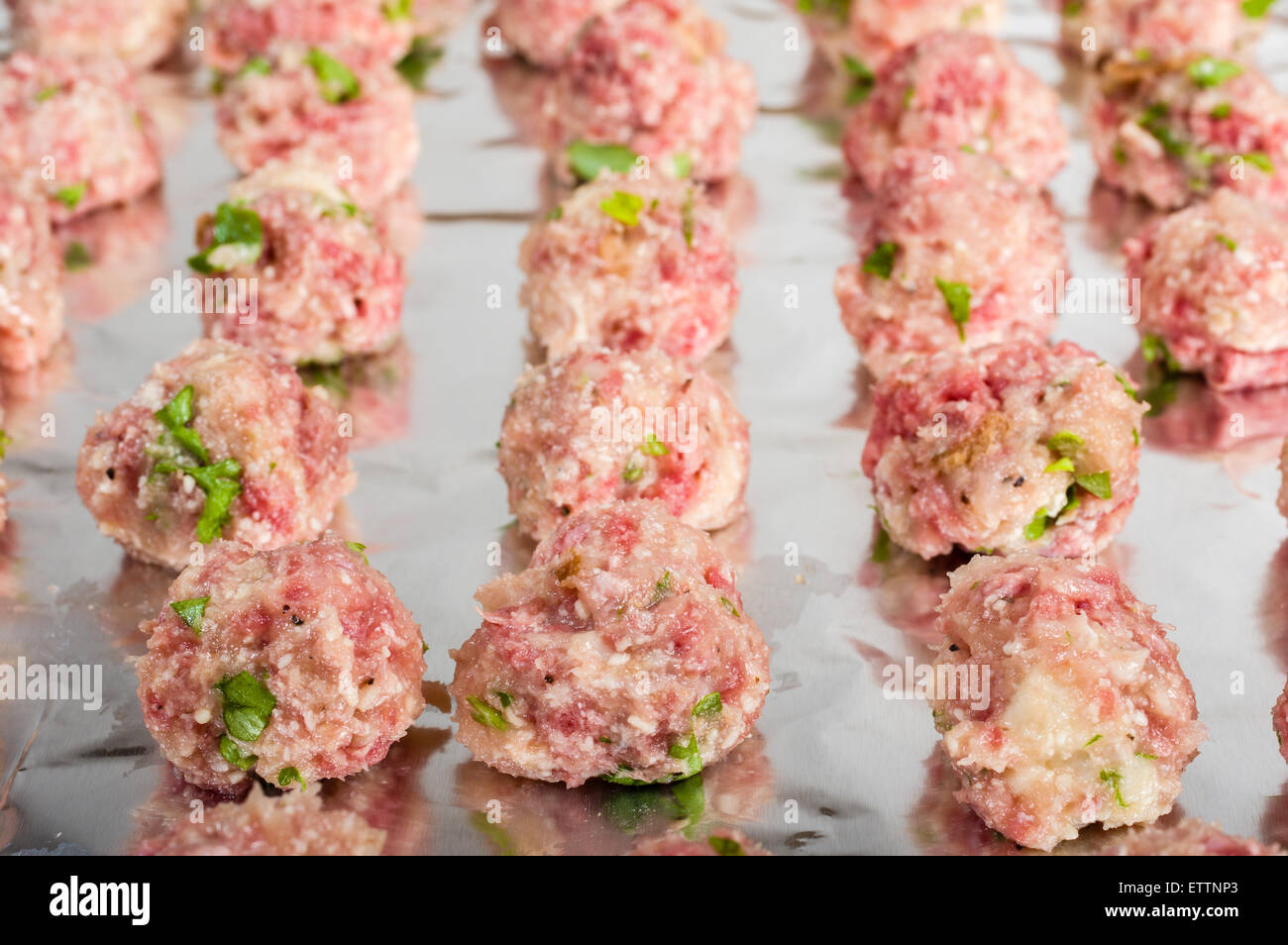 A tray of portioned raw meatballs ready to bake Stock Photo - Alamy