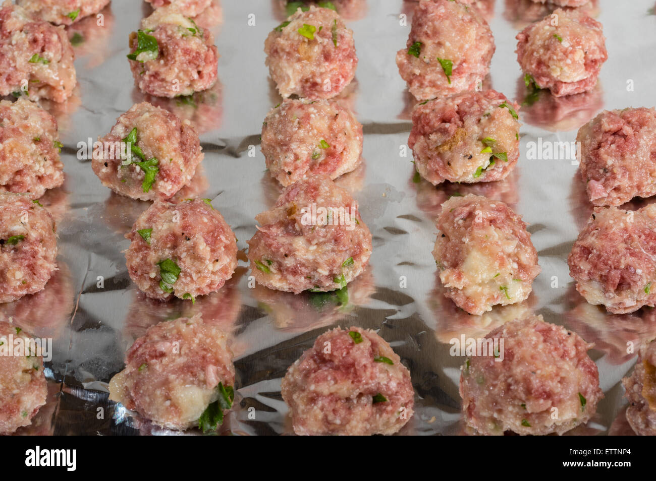 A tray of portioned raw meatballs ready to bake Stock Photo - Alamy