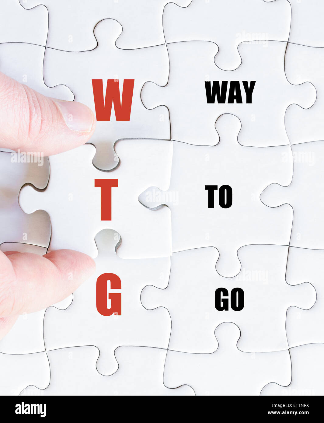 Hand of a business man completing the puzzle with the last missing ...