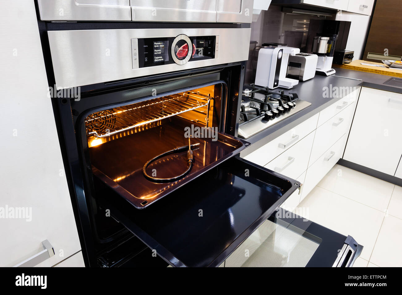 Modern hi-tek kitchen, oven with open door Stock Photo - Alamy