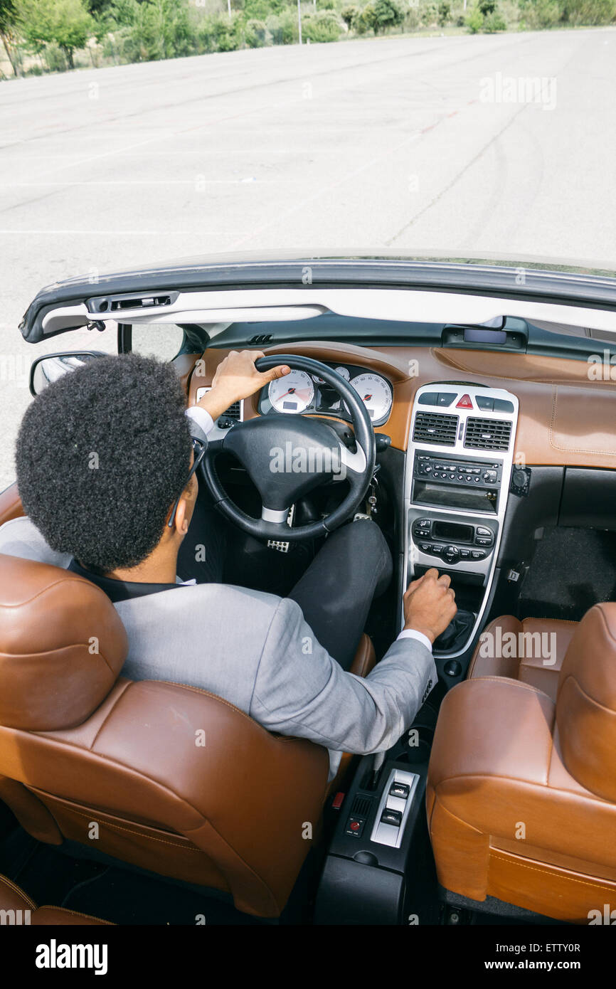 Young black man driving convertible Stock Photo - Alamy