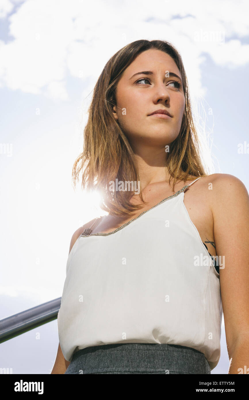 Young woman outdoors looking around Stock Photo - Alamy