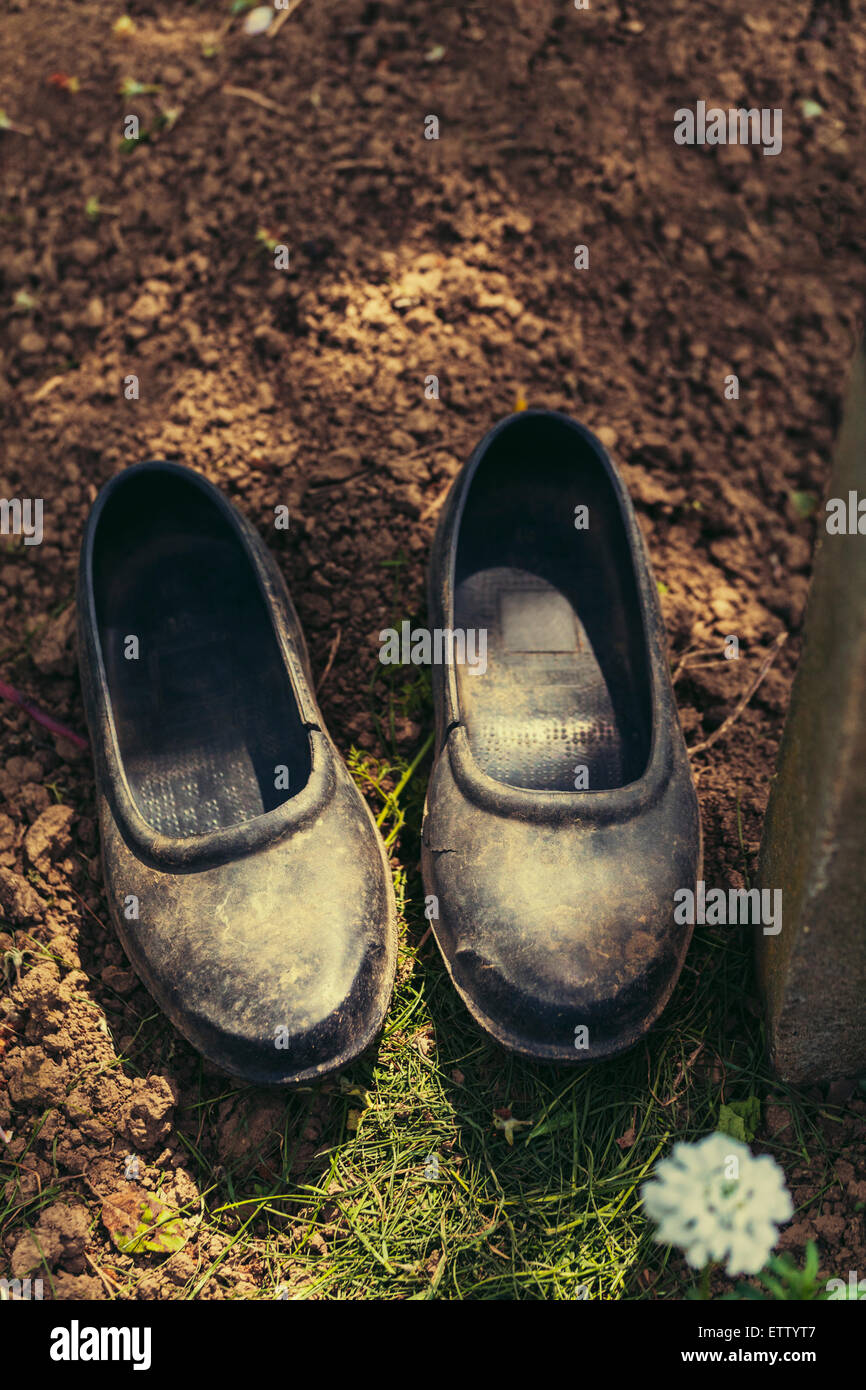 Pair of used black rubber garden shoes Stock Photo - Alamy